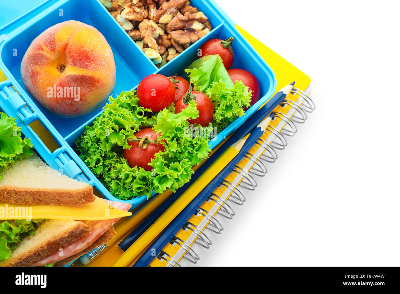 Lunch box with appetizing food and stationery on white background Stock ...