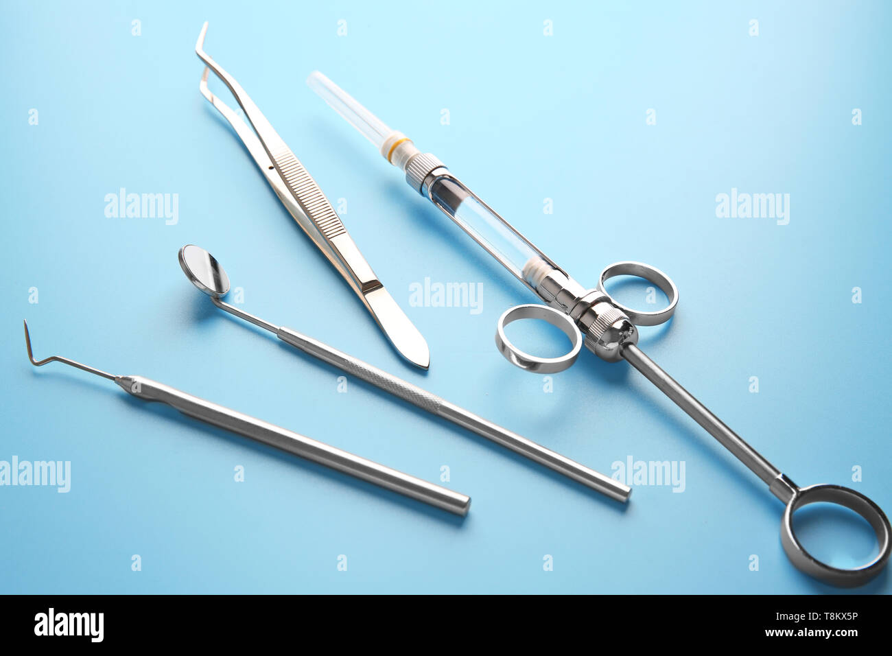 Dentist's tools on color background Stock Photo - Alamy
