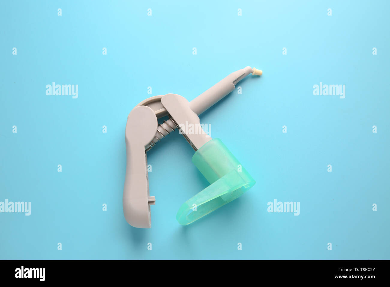 Compule tip gun on color background Stock Photo - Alamy