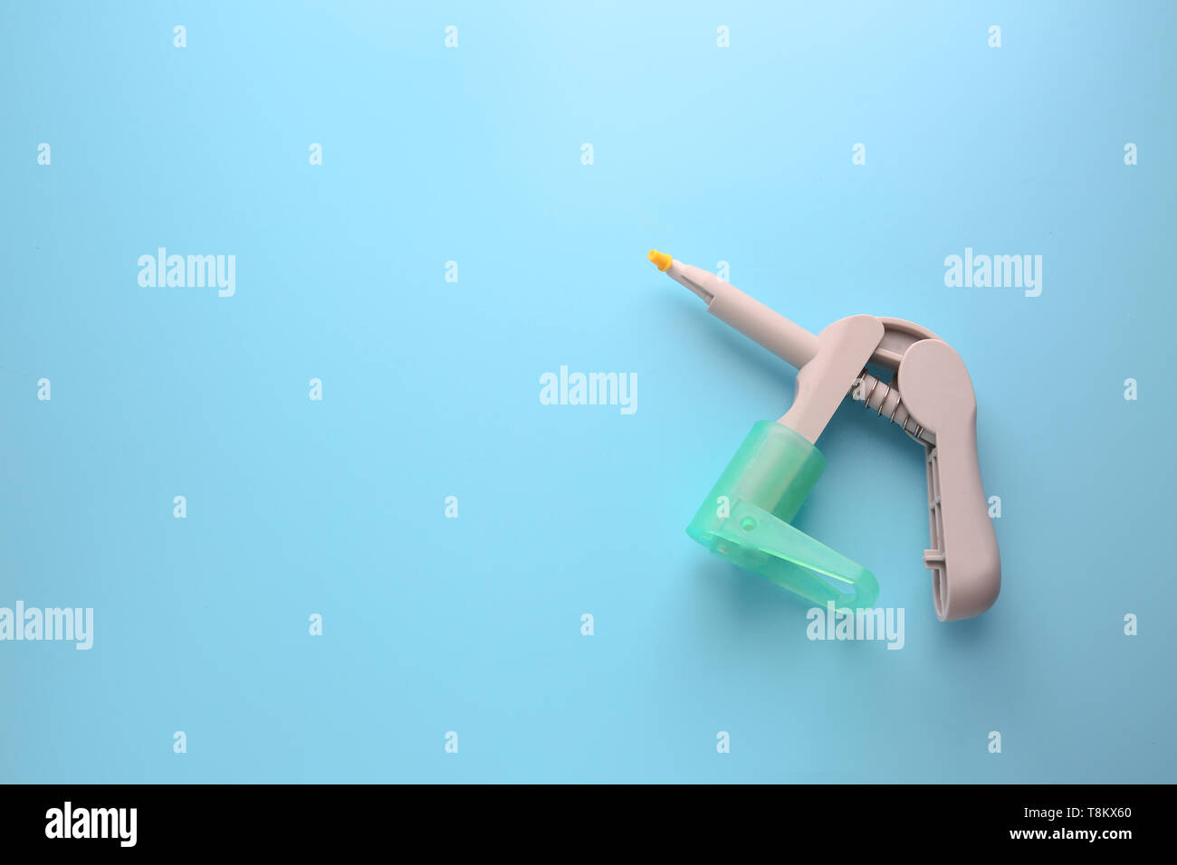 Compule tip gun on color background Stock Photo - Alamy