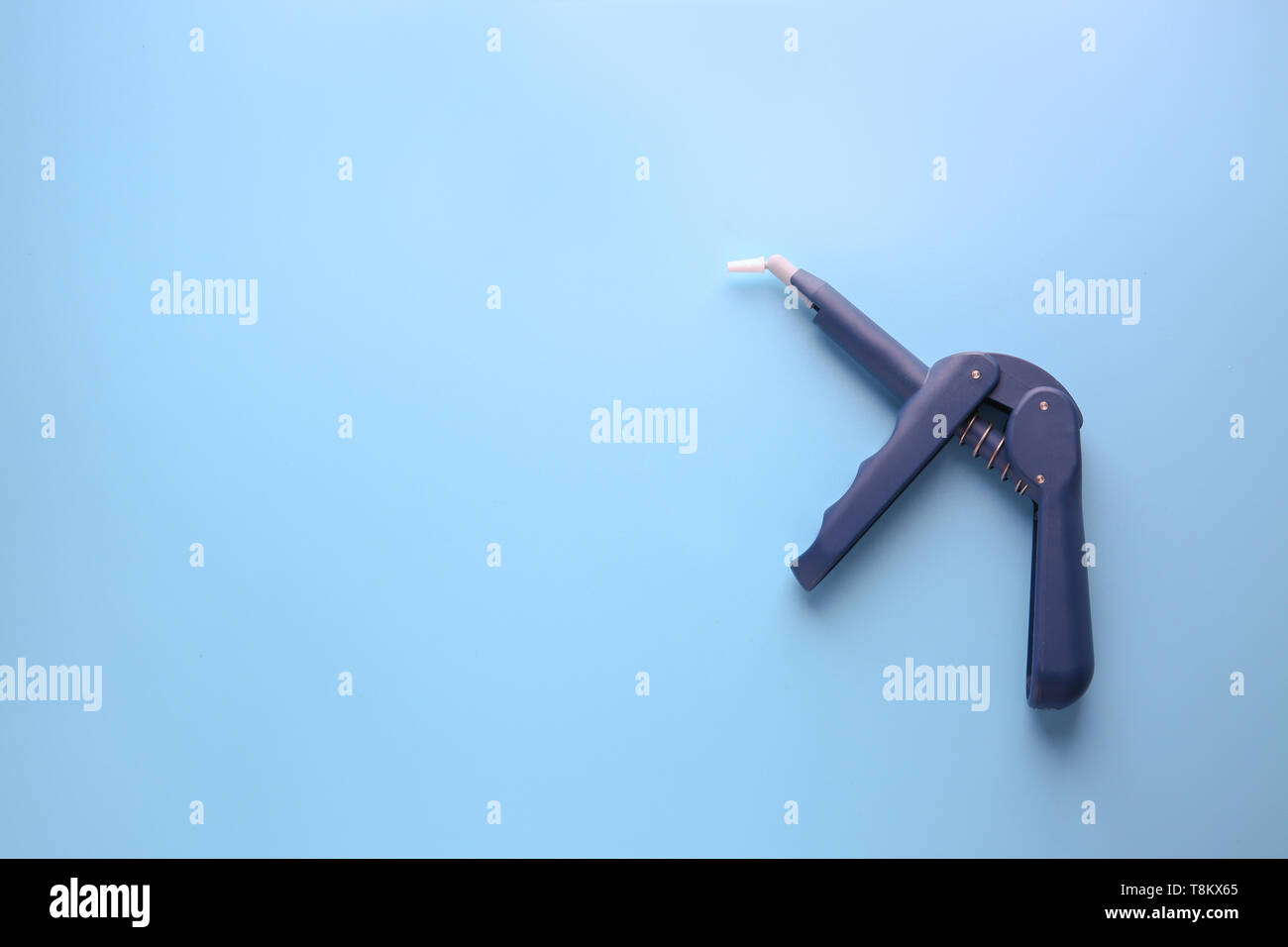 Compule tip gun on color background Stock Photo - Alamy