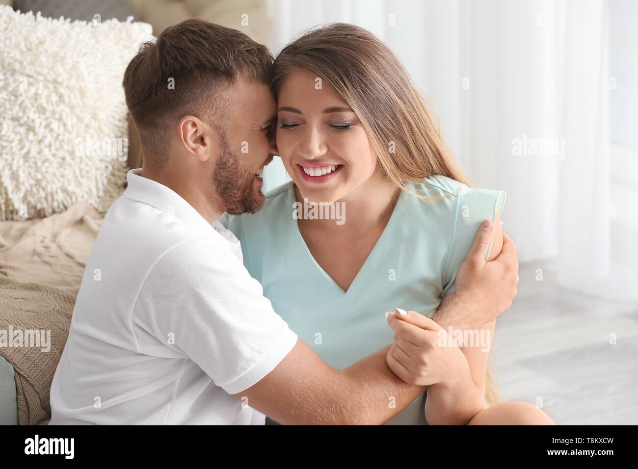 Happy loving couple resting at home Stock Photo - Alamy