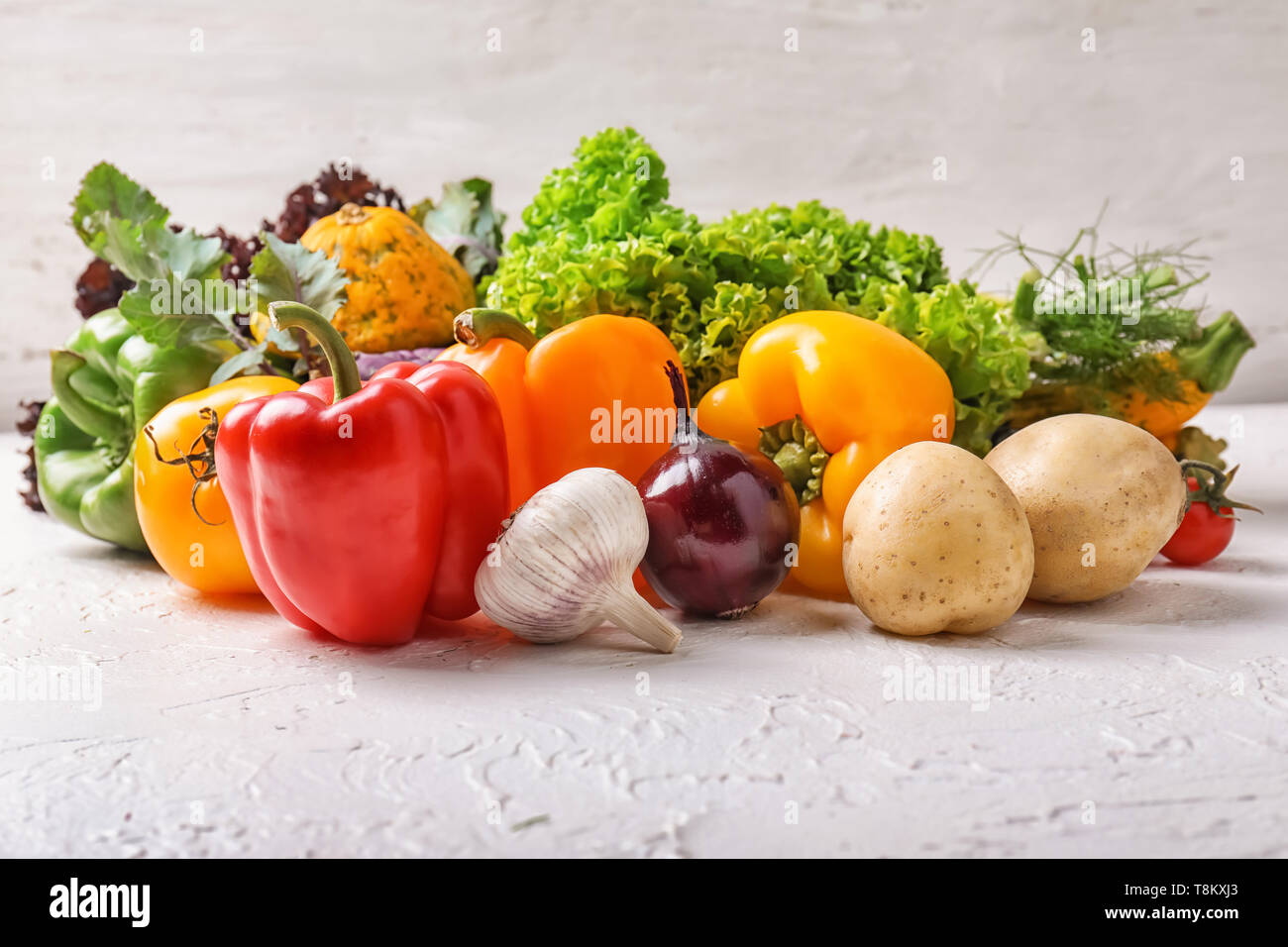 Different fresh vegetables on light background Stock Photo - Alamy