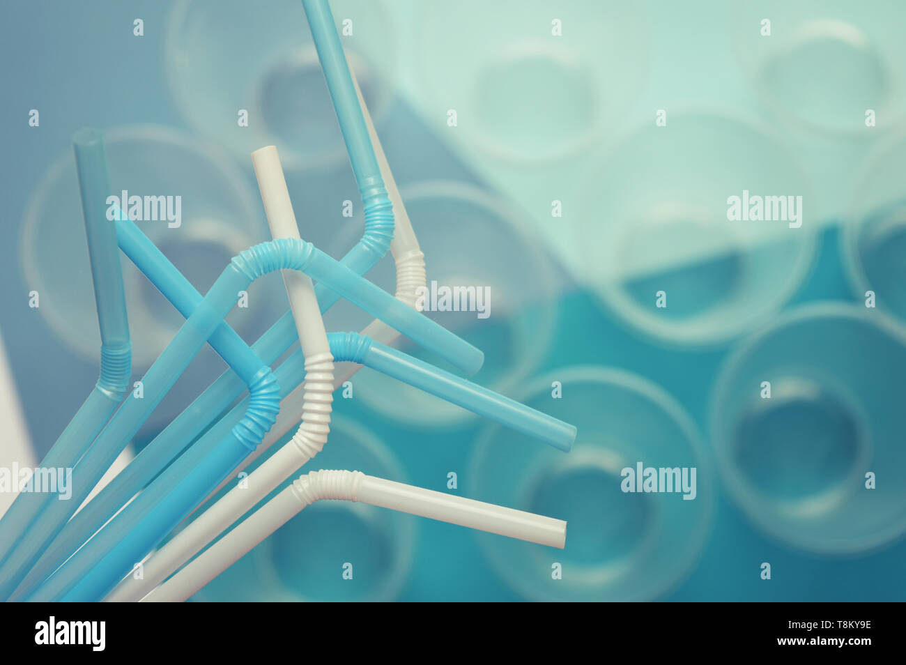 White and blue plastic tubes, turquoise tone. Selective focus, top view ...