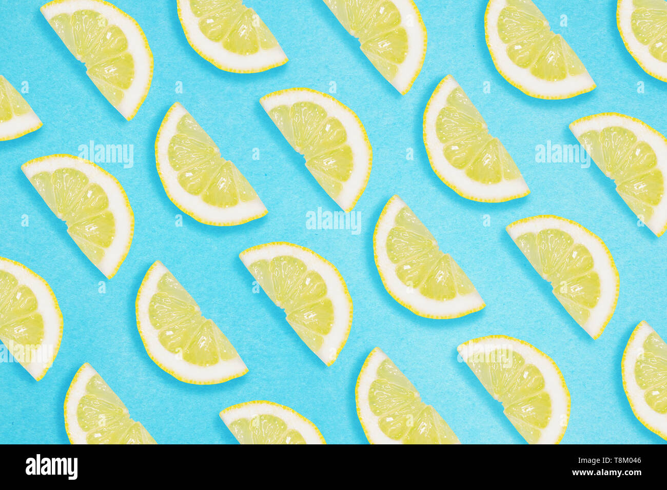Border of lemon slices on a blue background. Flat lay summer concept ...