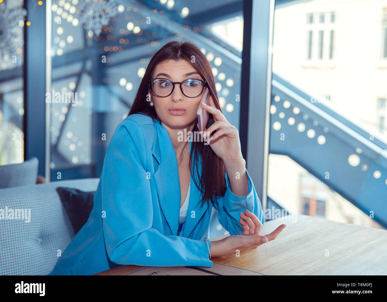 Closeup portrait of a beautiful woman shrugging shoulders puzzled while ...