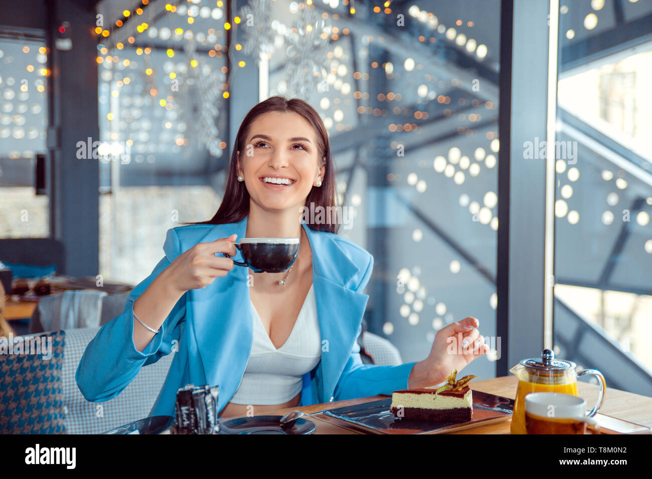 Cafe city lifestyle. Indian woman sitting at in the living room or a ...