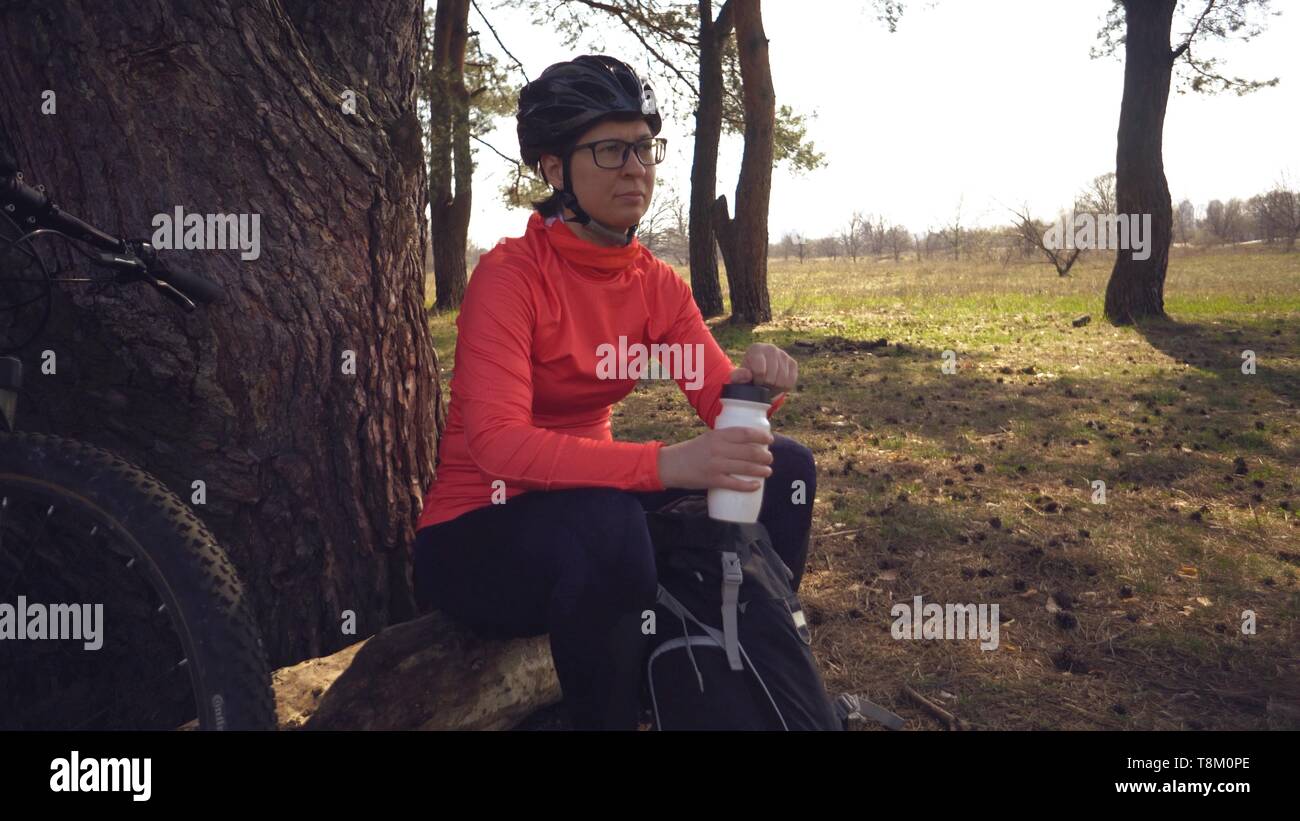 Theme sports and tourism in nature. Caucasian young woman cyclist in a ...