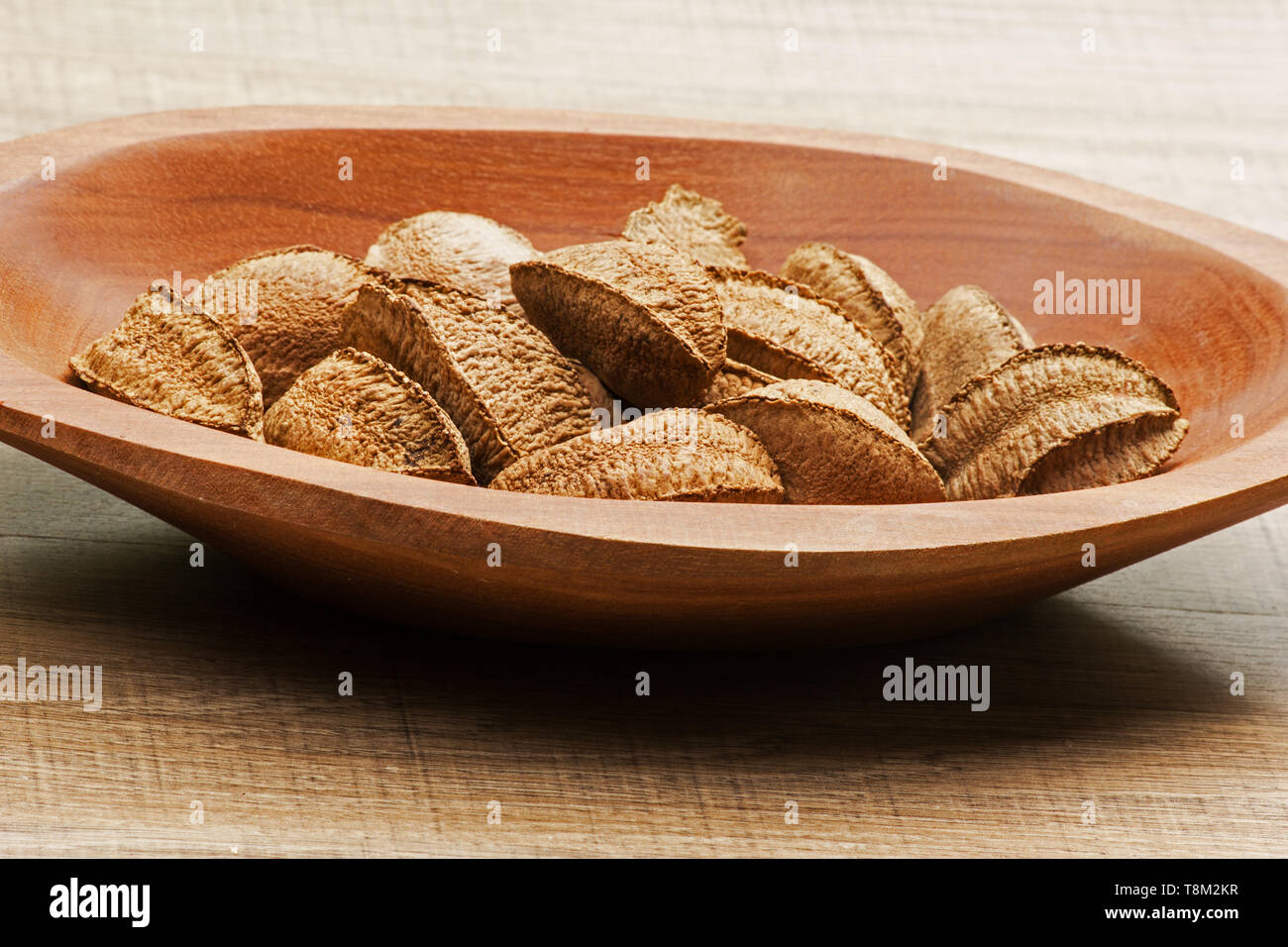 Brazil nuts in a wooden bowl Stock Photo - Alamy