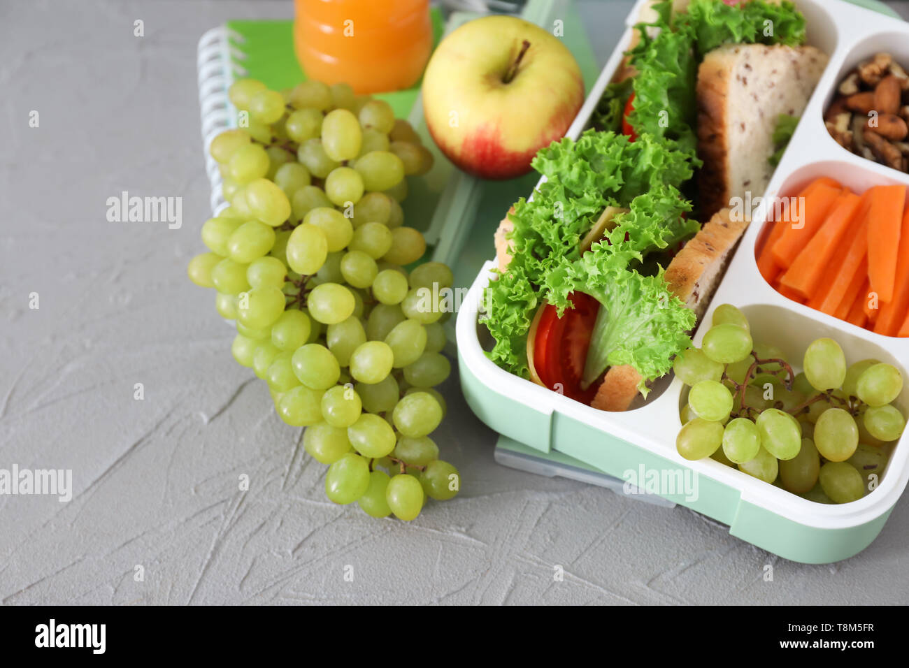 Lunch box with appetizing food on table Stock Photo - Alamy