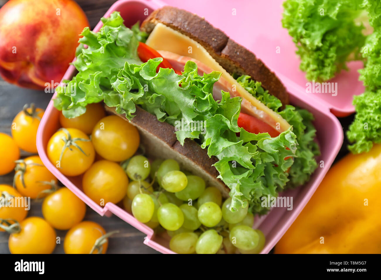 Lunch box with appetizing food on table Stock Photo - Alamy