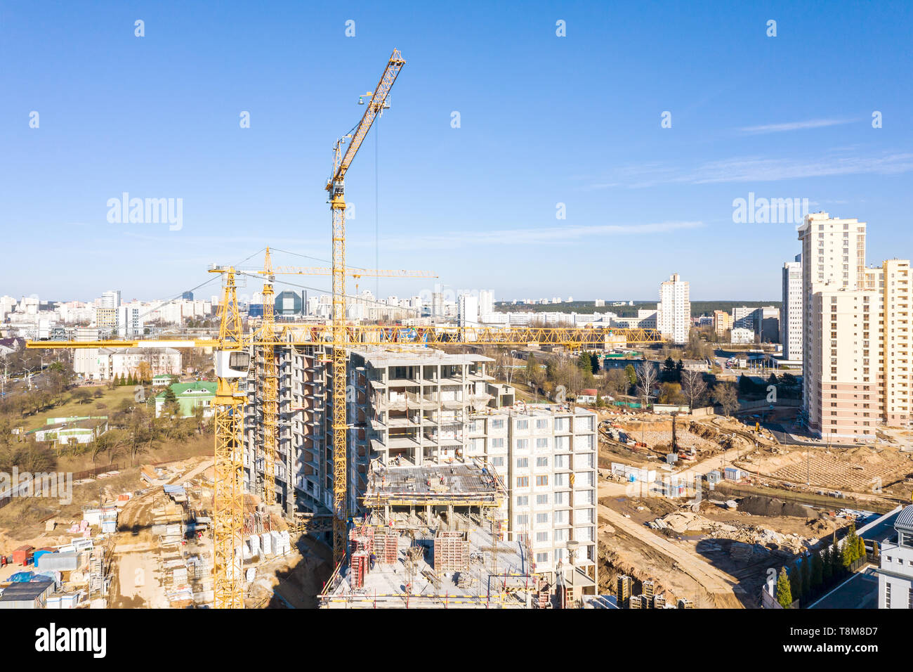 aerial panoramic view of city construction site with high yellow tower ...