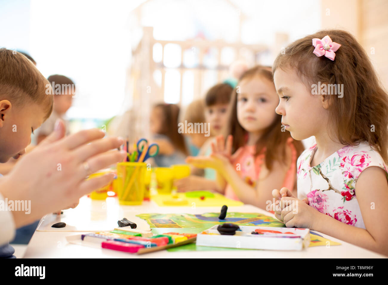 kids group learning arts and crafts in kindergarten or day care centre ...
