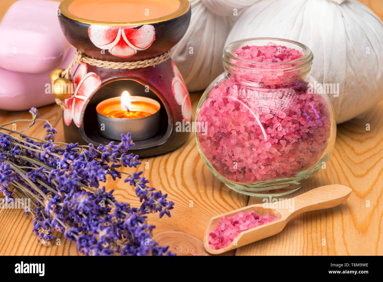 bunch of dried lavender, sea salt and burning candle spa objects close ...