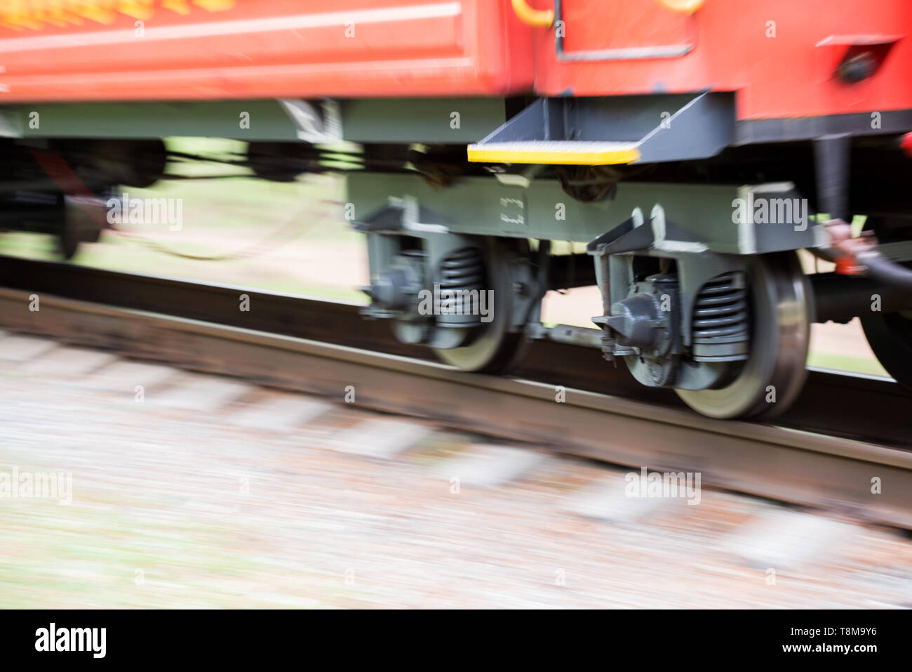 Motion blurred wheels of a moving train carriage closeup. Railway car ...