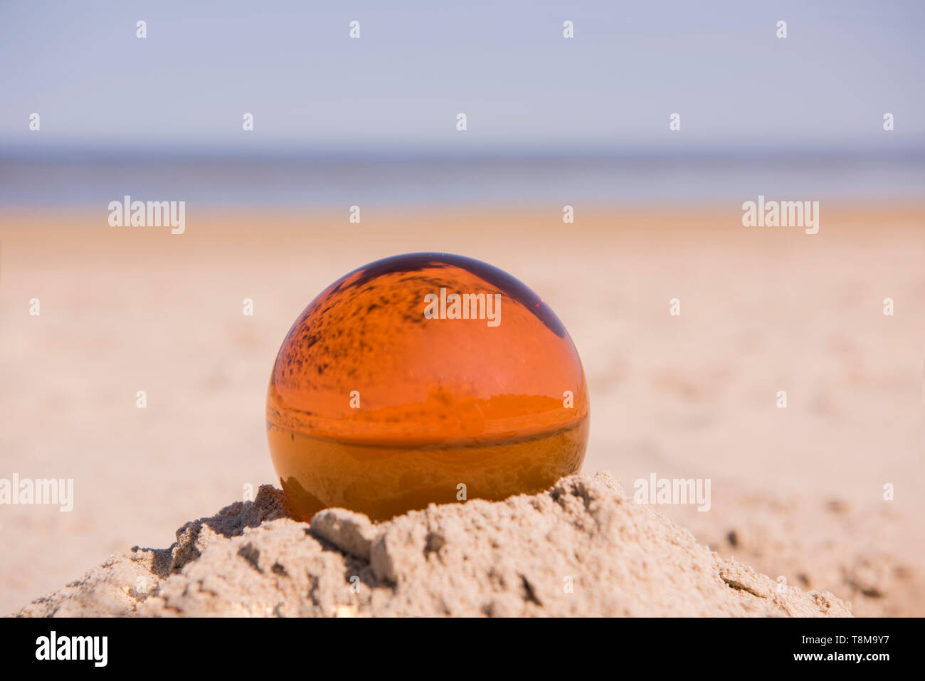 Glass sphere at the beach. Sunny summer day Stock Photo - Alamy
