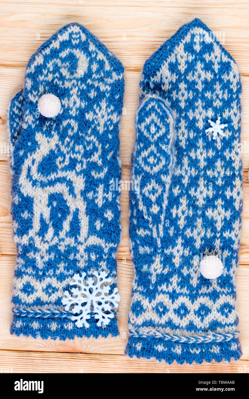 handmade blue mittens with a deer pattern are warm and soft close-ups ...