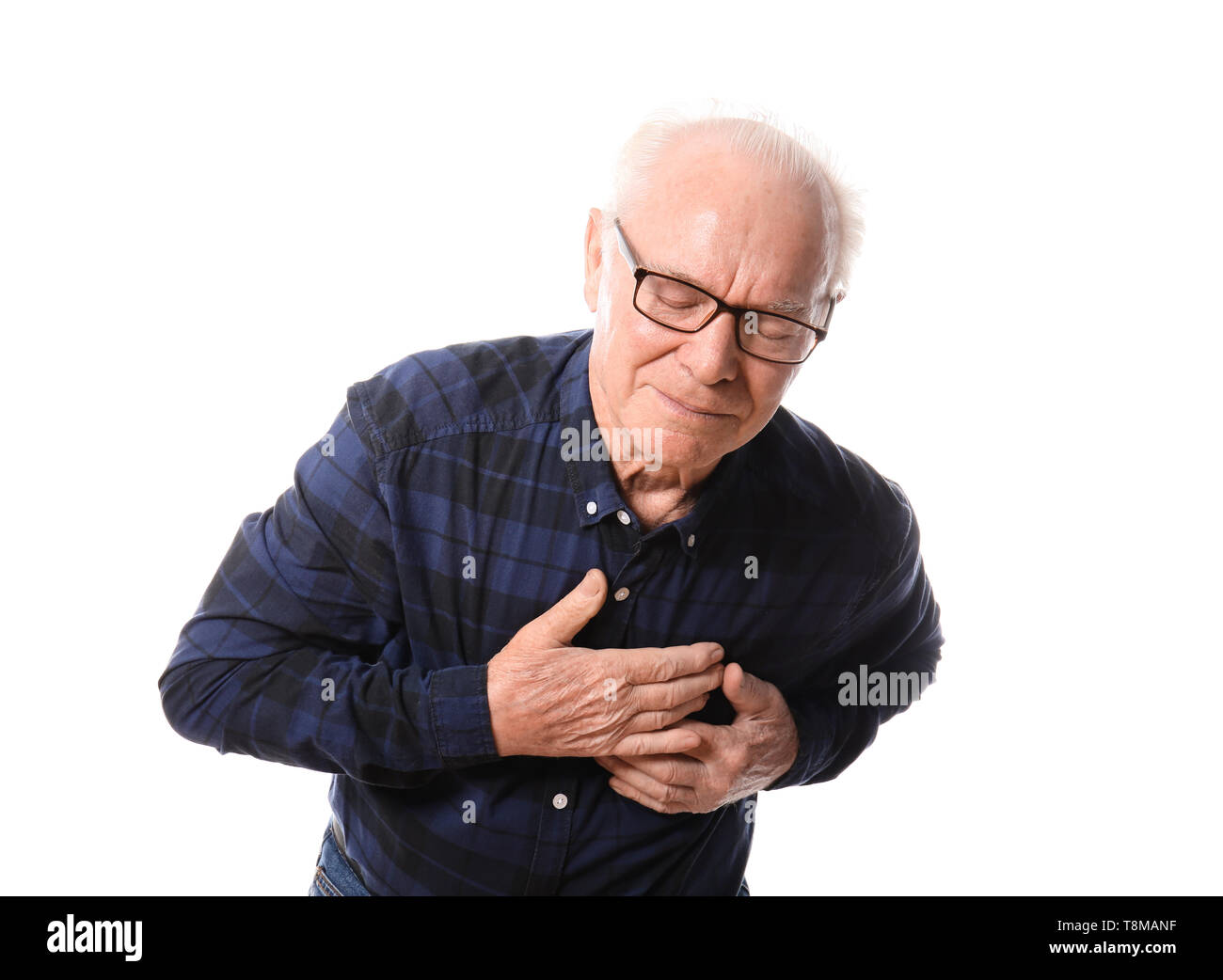 Senior man suffering from heart attack against white background Stock ...