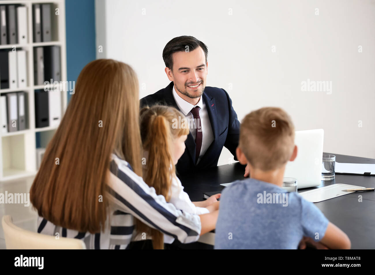 Young woman and her children meeting with headmaster at school Stock ...