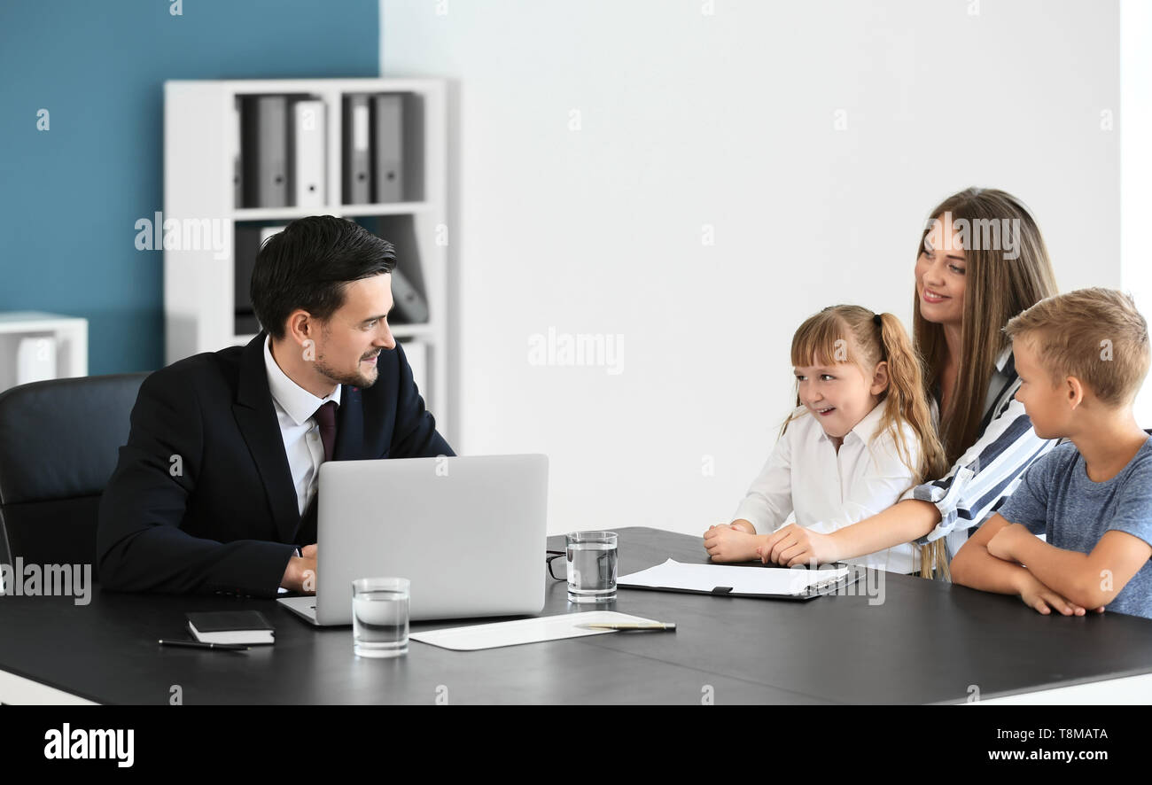 Young woman and her children meeting with headmaster at school Stock ...