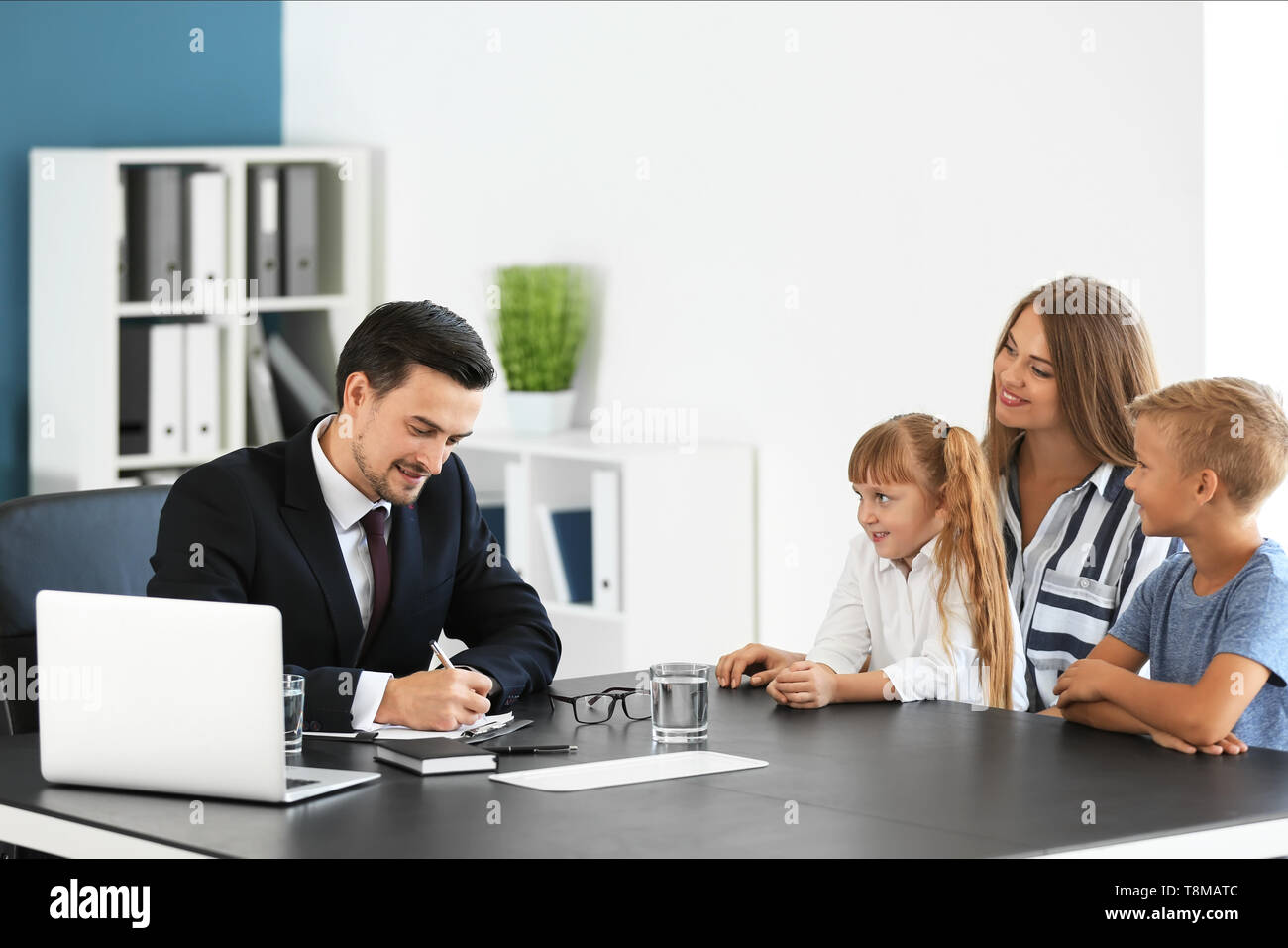 Young woman and her children meeting with headmaster at school Stock ...