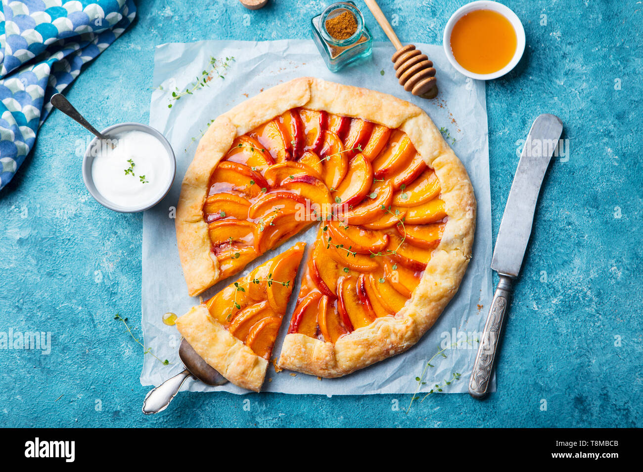 Peach galette, pie, cake with cream on blue background. Top view Stock ...