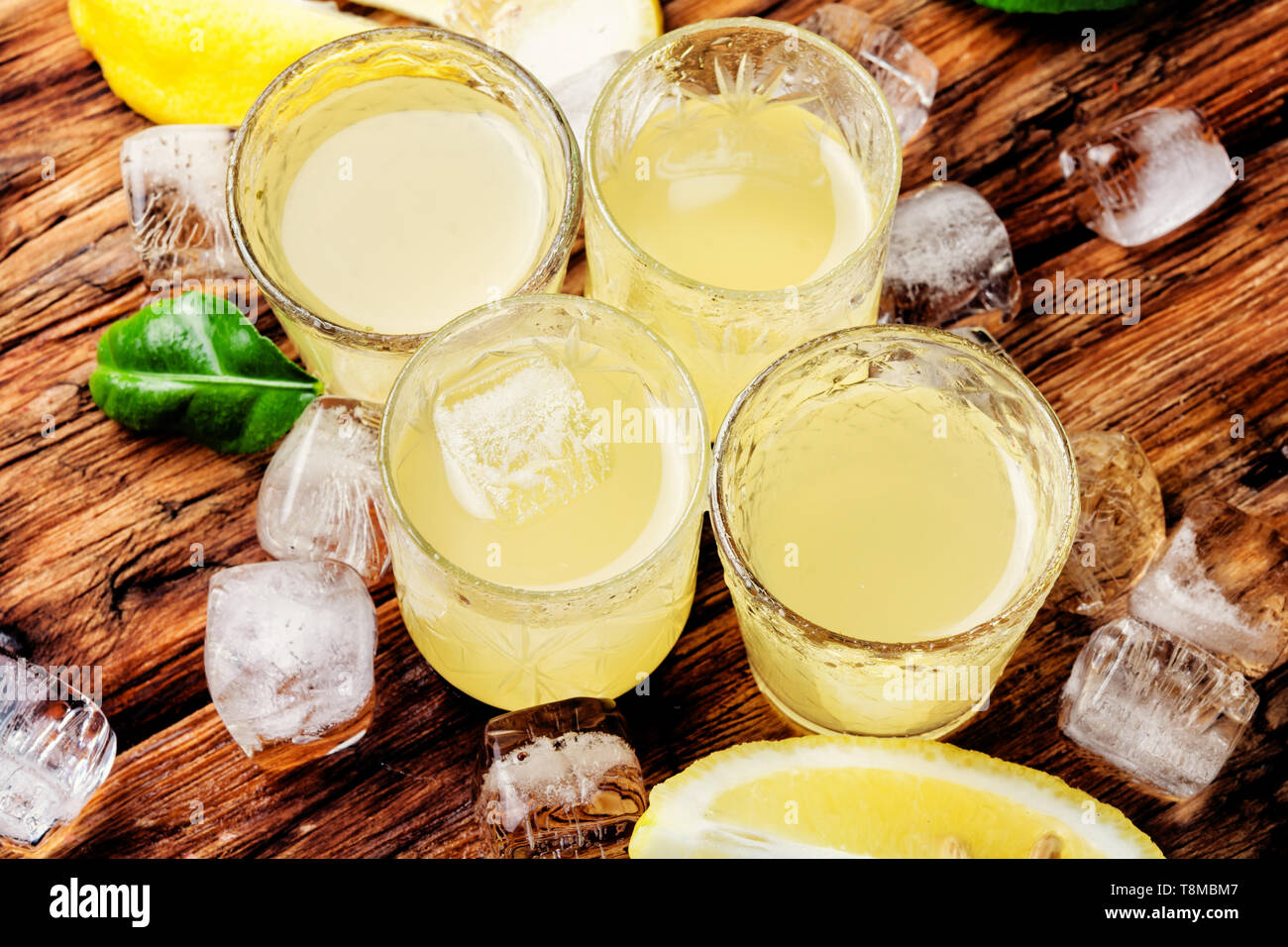 Traditional italian lemon liqueur limoncello and fresh lemon.Summer ...