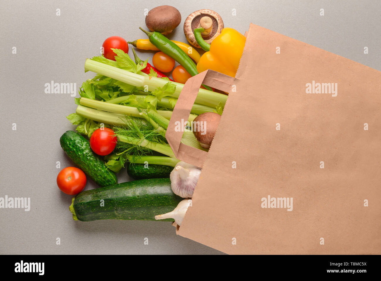 Paper bag with various fresh vegetables on grey background Stock Photo ...
