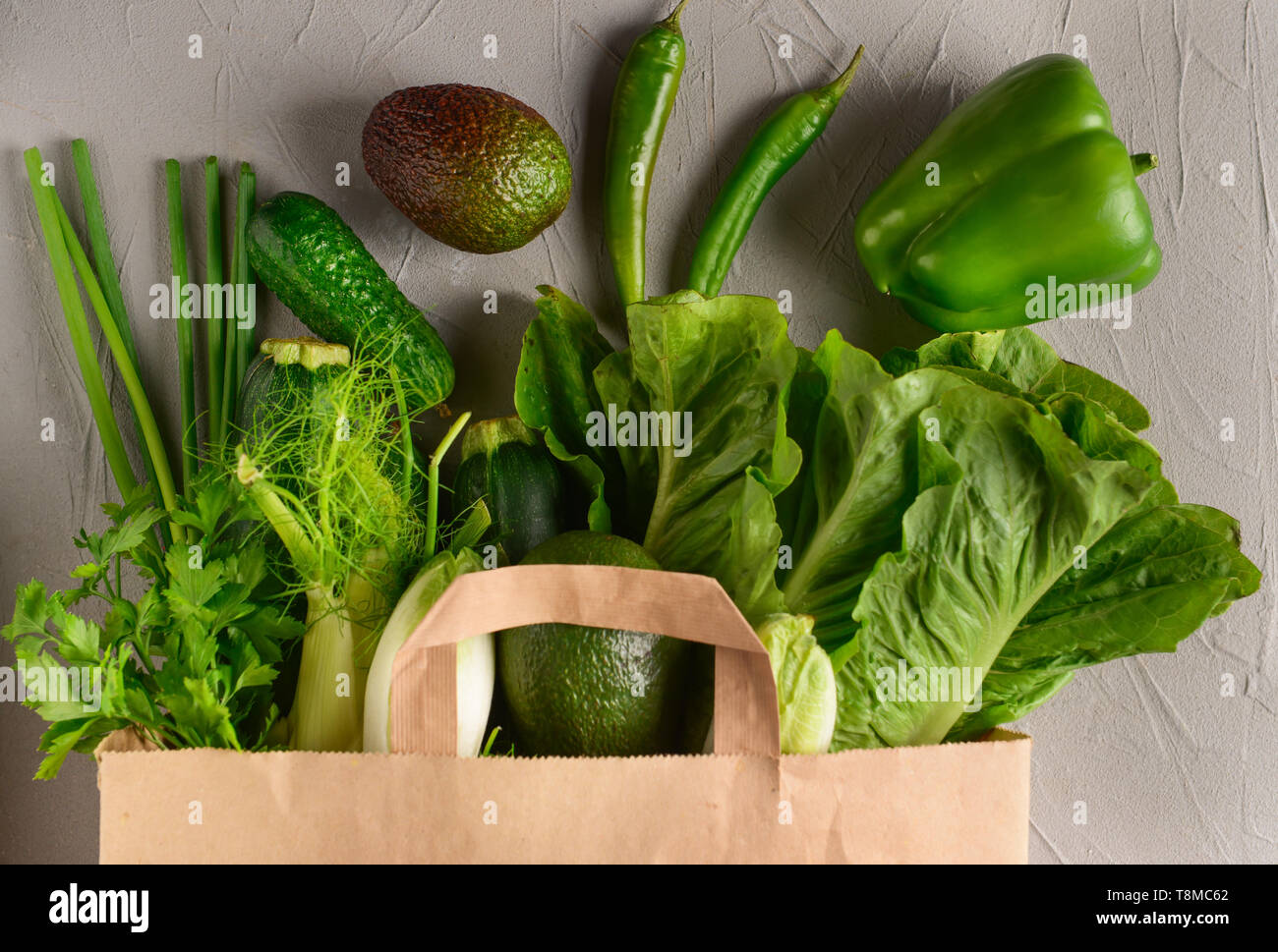 Paper bag with various fresh vegetables on grey background Stock Photo ...