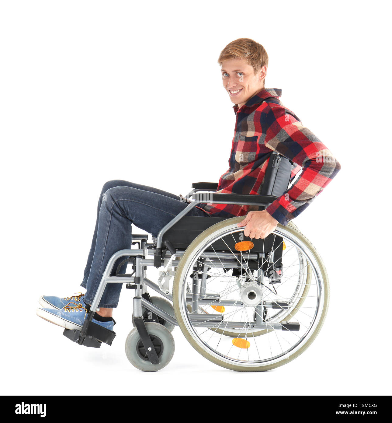Young man sitting in wheelchair on white background Stock Photo - Alamy