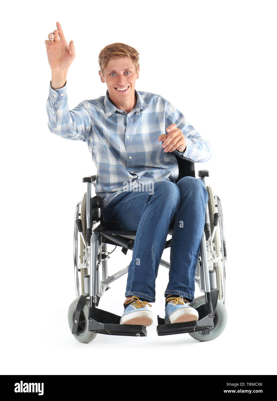 Young man sitting in wheelchair on white background Stock Photo - Alamy
