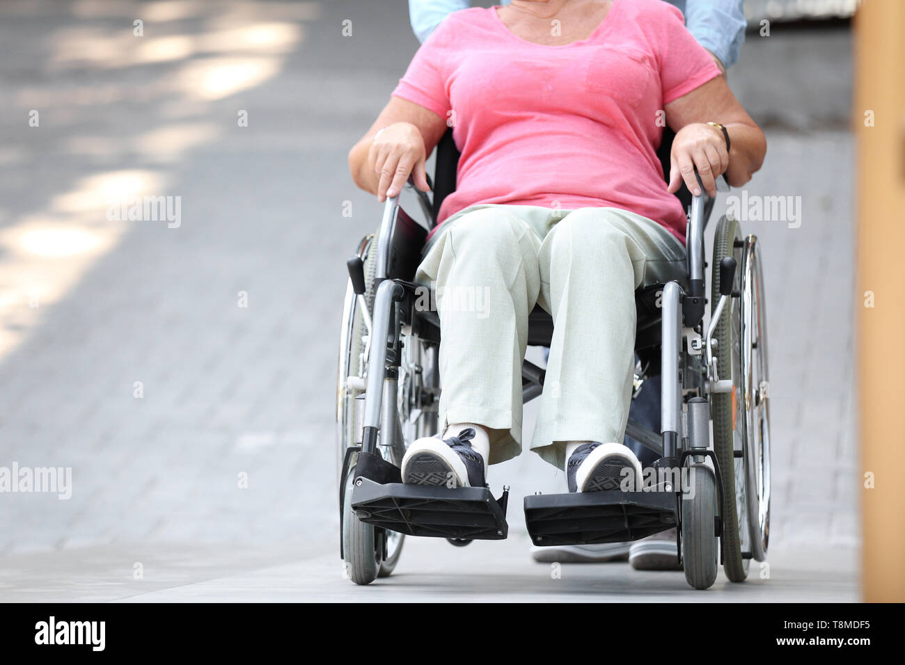 Senior woman in wheelchair on ramp outdoors Stock Photo - Alamy