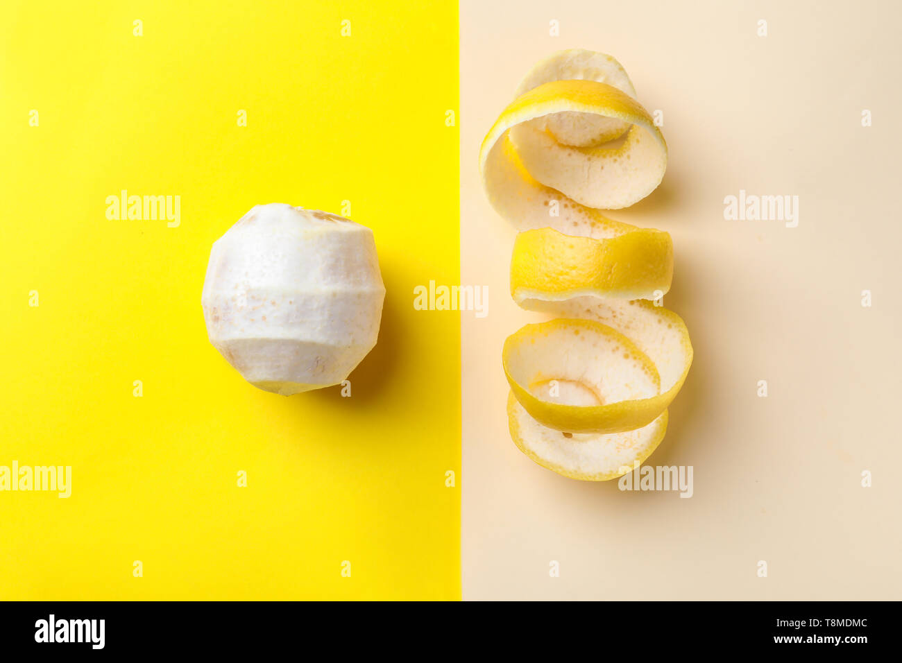 Peeled lemon and peel on color background Stock Photo - Alamy