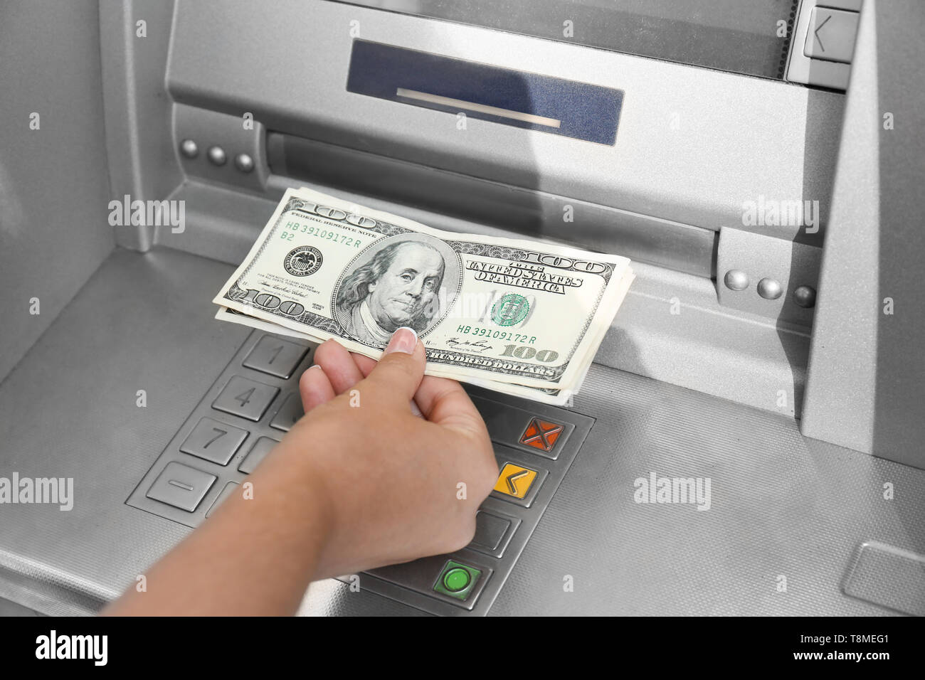 Young woman taking money from the atm hi-res stock photography and ...