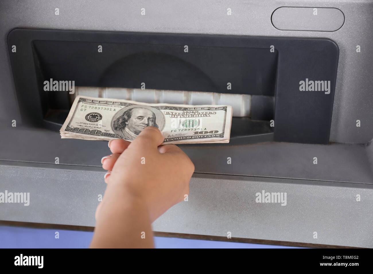 Young woman taking money from the atm hi-res stock photography and ...
