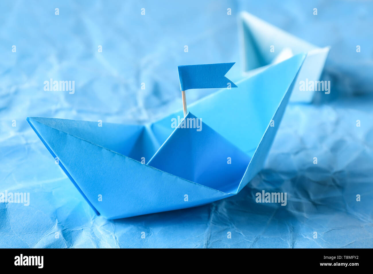 Origami boat on crumpled paper Stock Photo - Alamy