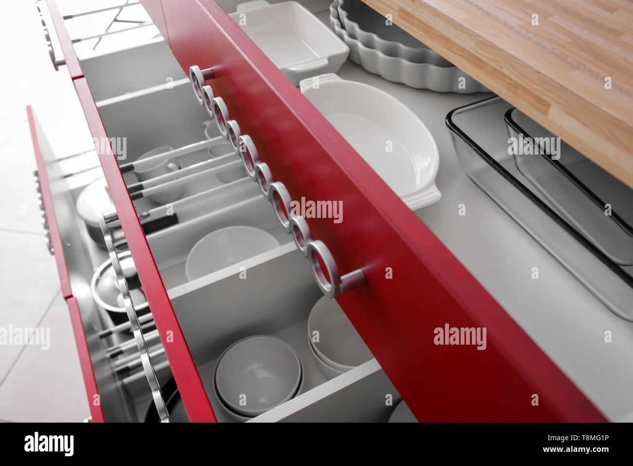Set of clean kitchenware in open drawers Stock Photo - Alamy