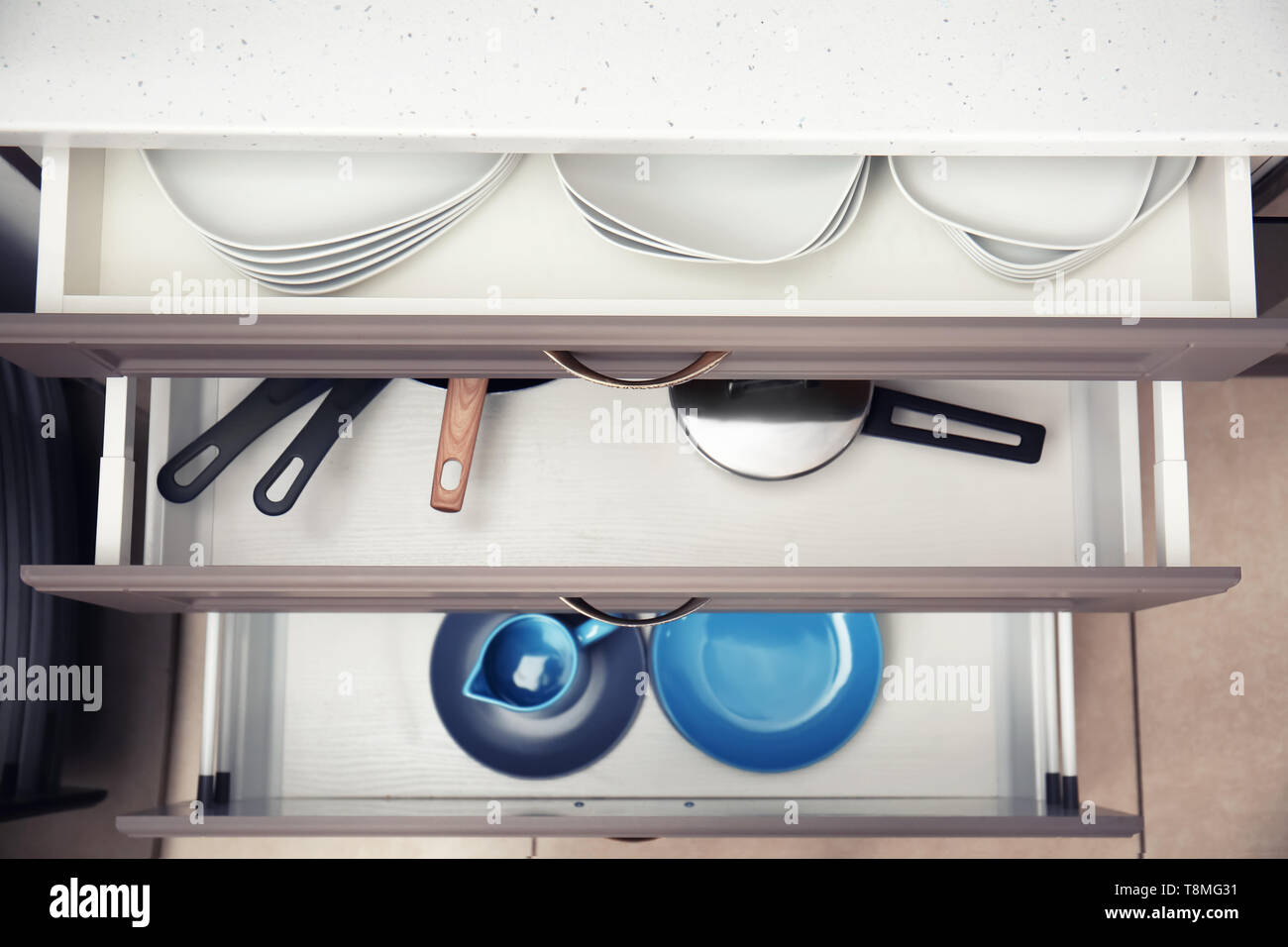 Set of clean kitchenware in open drawers Stock Photo - Alamy