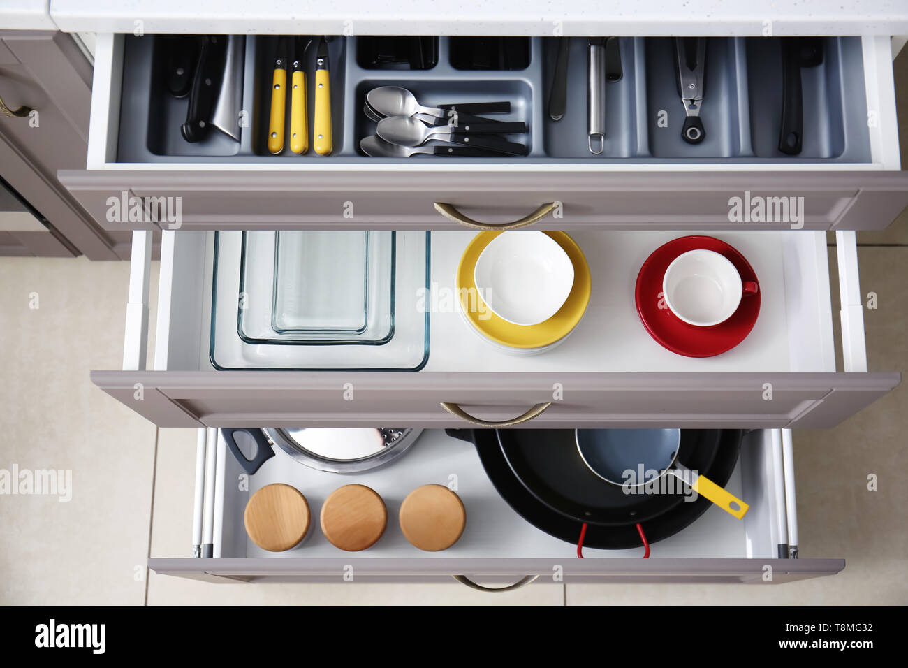Set of clean kitchenware and utensils in drawers Stock Photo - Alamy
