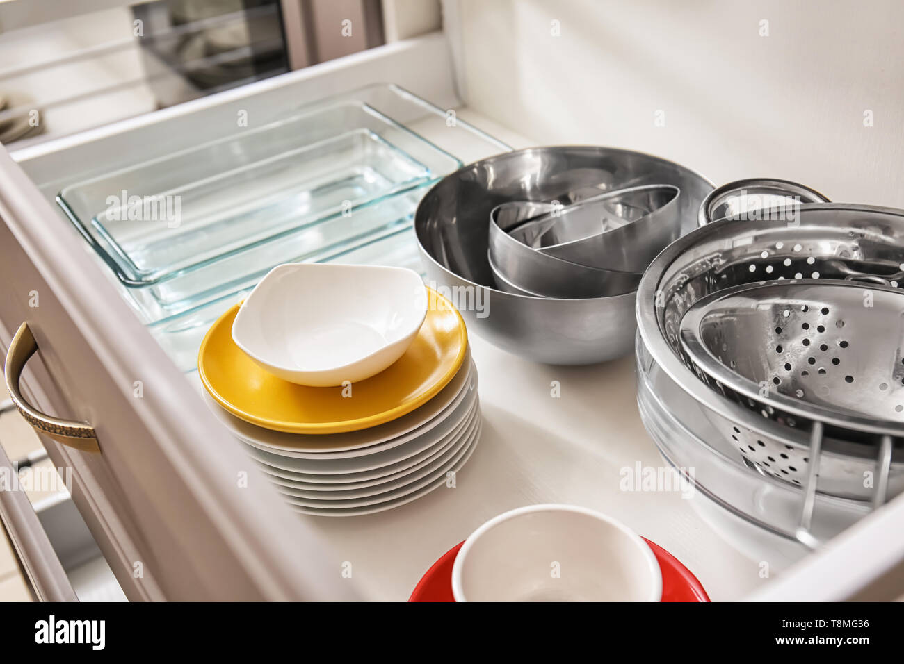 Set of clean kitchenware in drawer Stock Photo - Alamy