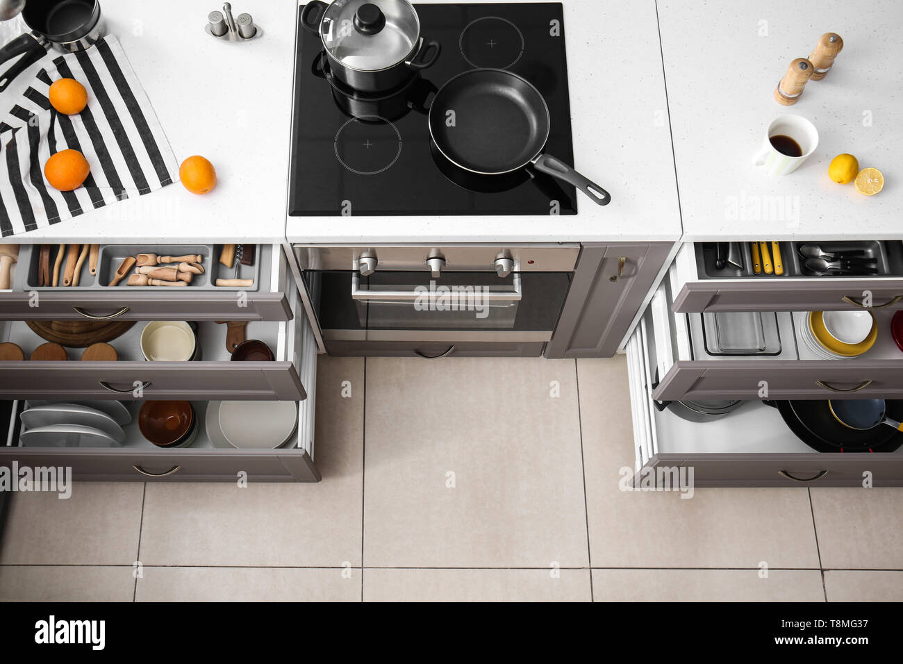 Set of clean kitchenware in open drawers Stock Photo - Alamy