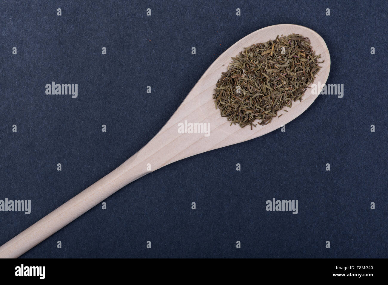 Heap of Dried Organic Culinary Thyme Herb in handmade wooden spoon on ...