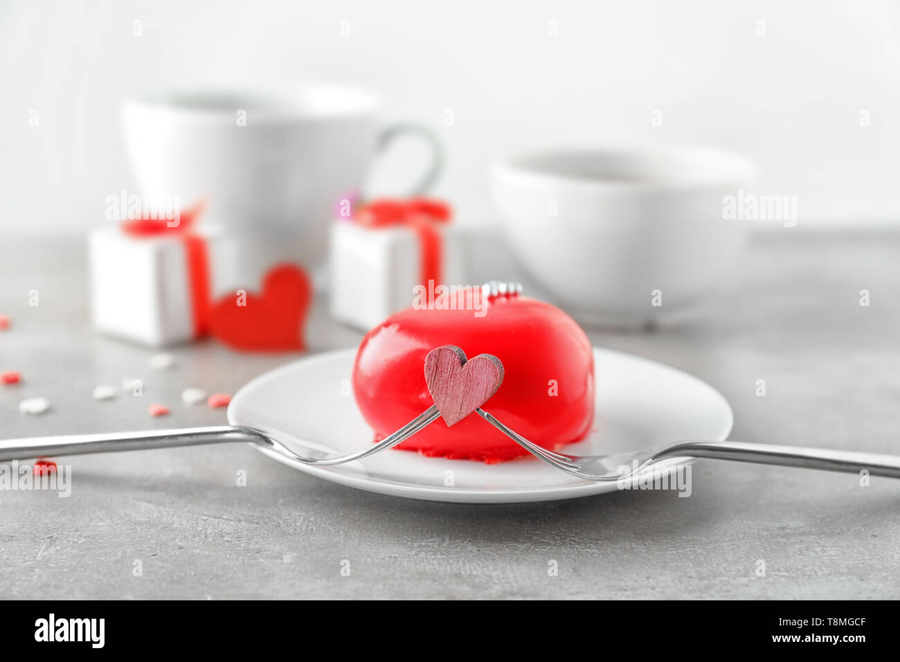 Color heart between two forks on plate with dessert Stock Photo - Alamy