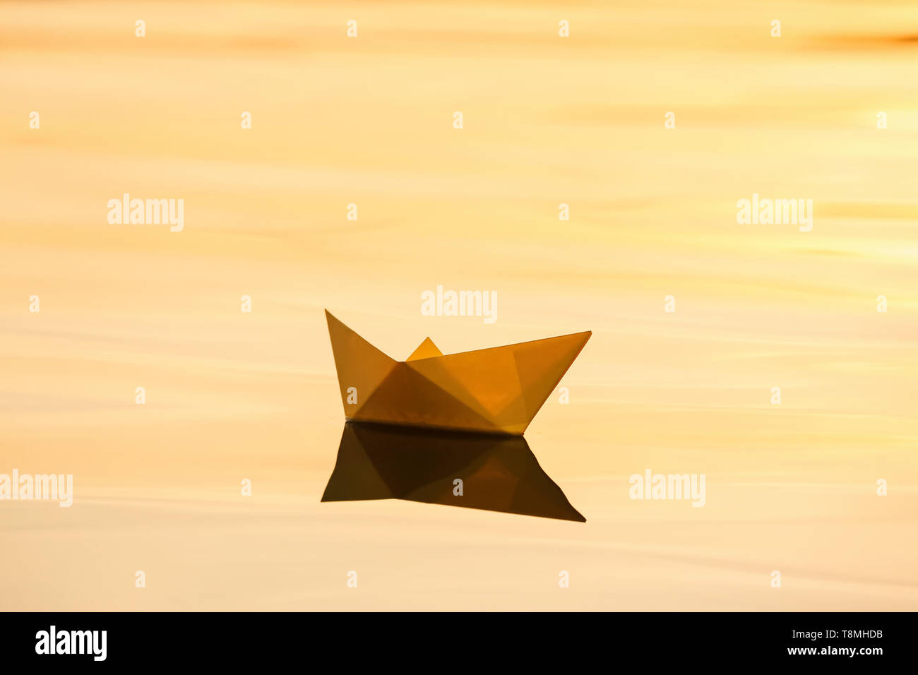 Origami boat on water surface Stock Photo - Alamy