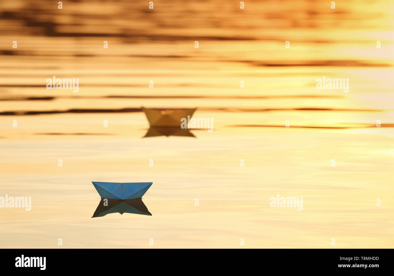 Origami boats on water surface at sunset Stock Photo - Alamy