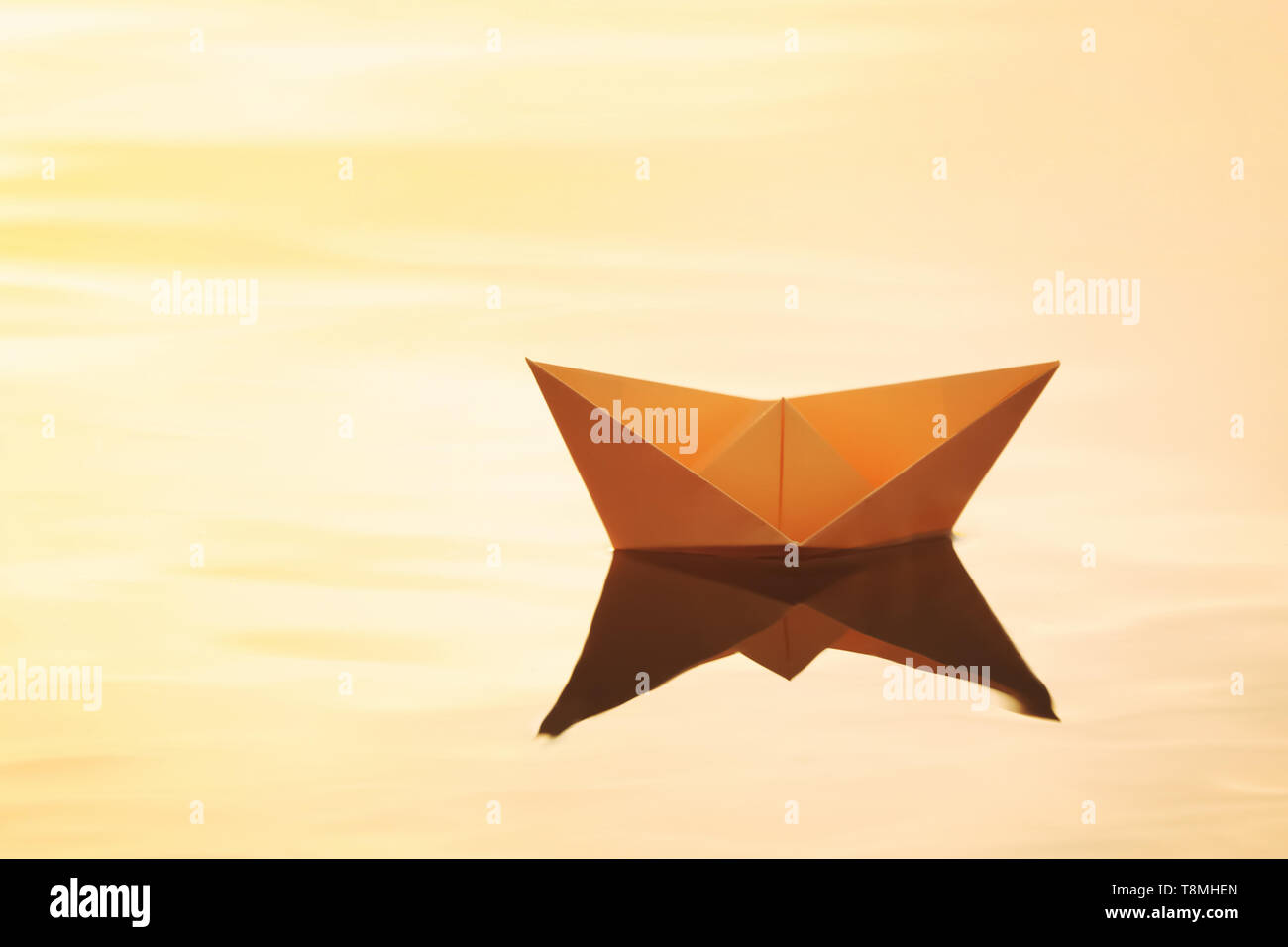 Origami boat on water surface Stock Photo - Alamy