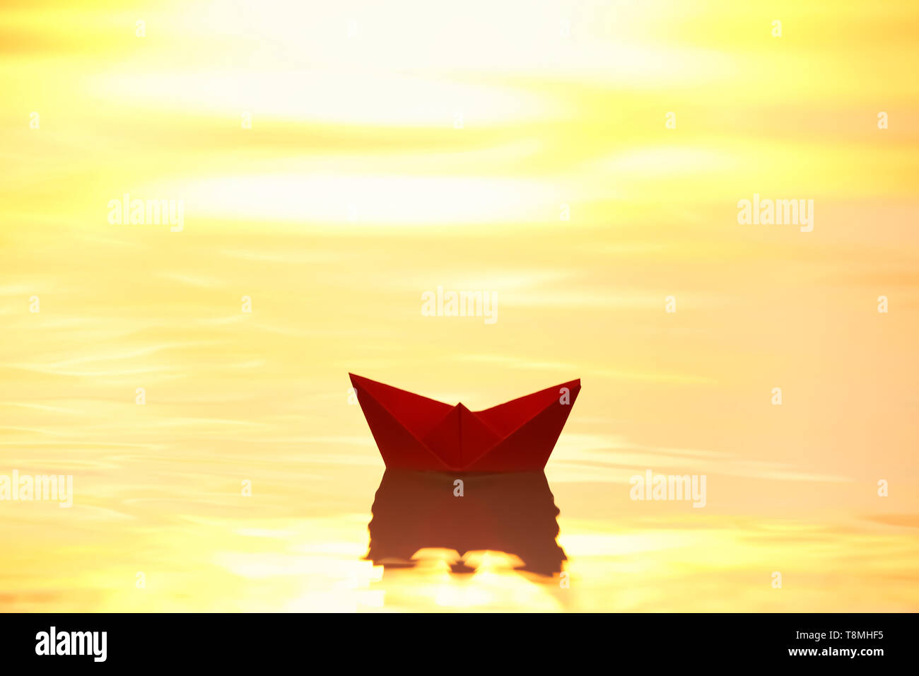 Origami boat on water surface at sunset Stock Photo - Alamy