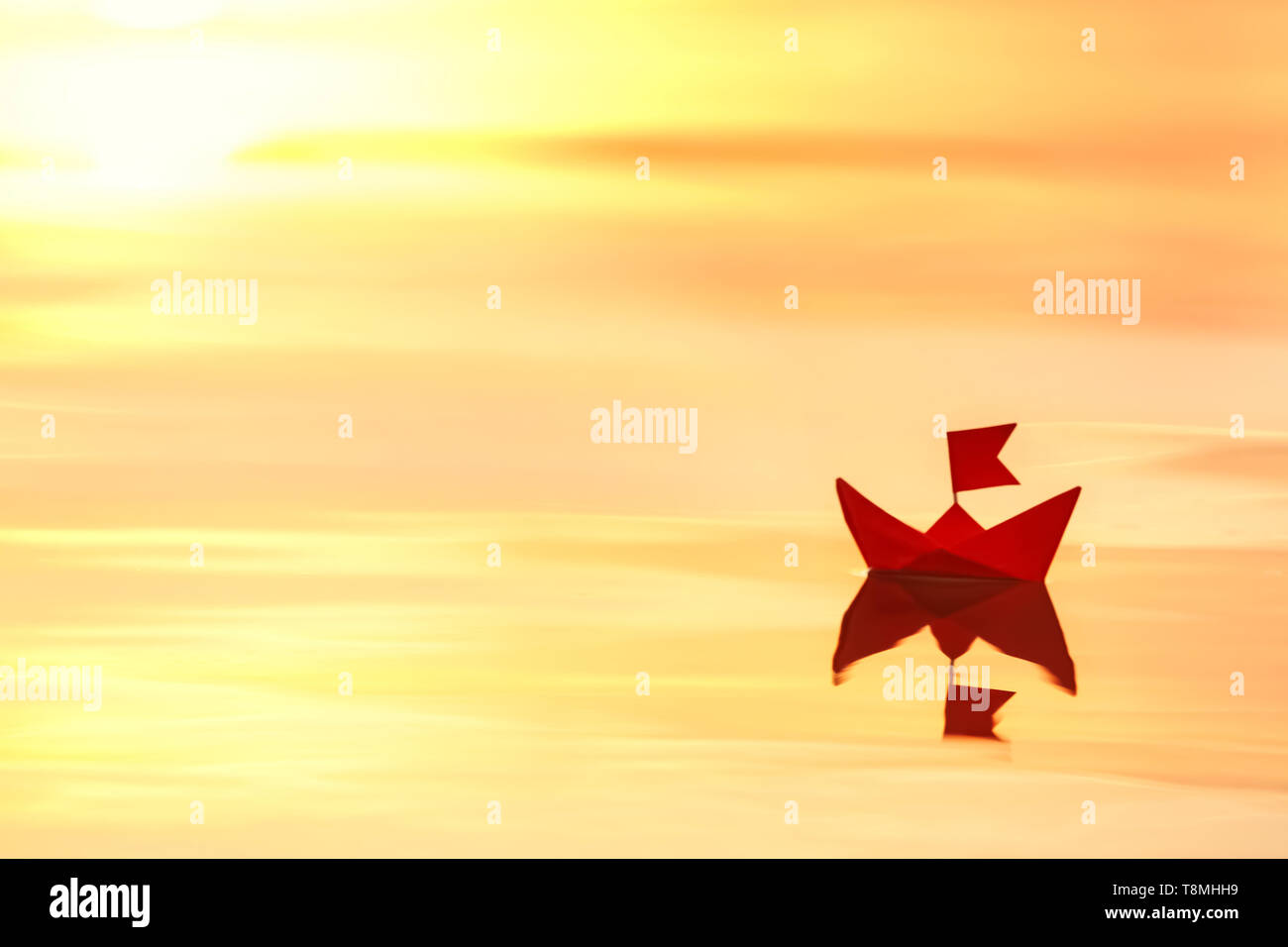 Origami boat on water surface Stock Photo - Alamy