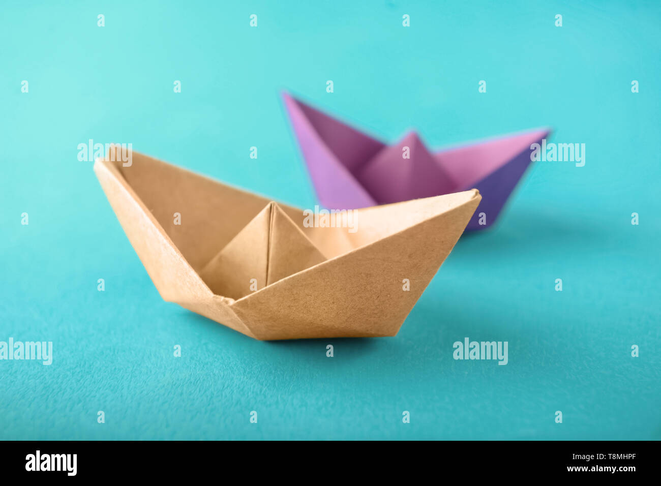 Origami boats on color background Stock Photo - Alamy