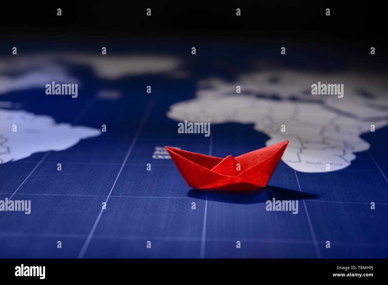 Origami boat on world map. Travel concept Stock Photo - Alamy